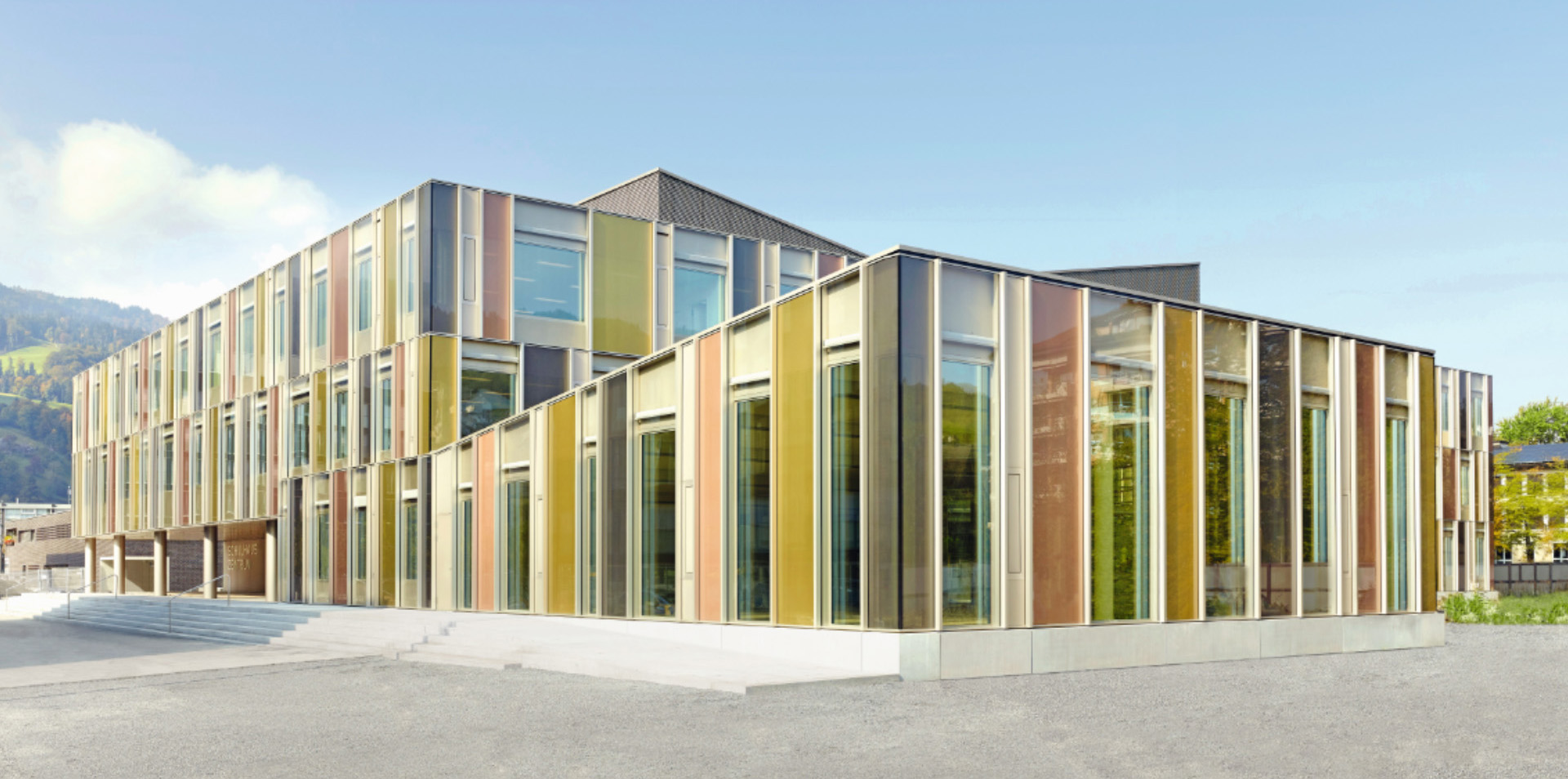 School complex in Switzerland. A facade made of colored glass for a ...