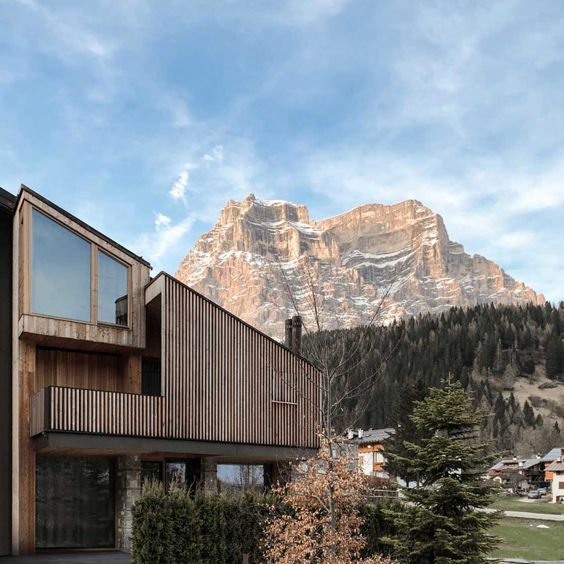 Restyling and expansion of a chalet. Wood is used to connect with ...