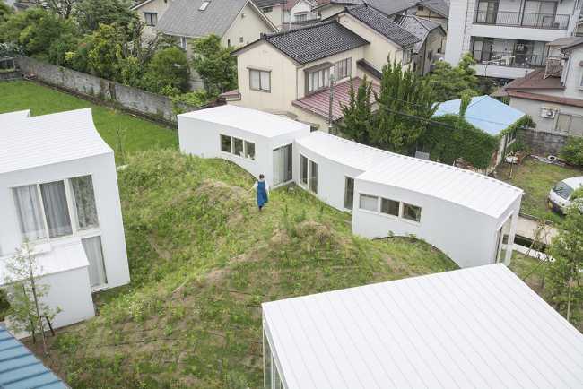 Three buildings built on a hill. Panoramic view of a mountainous landscape