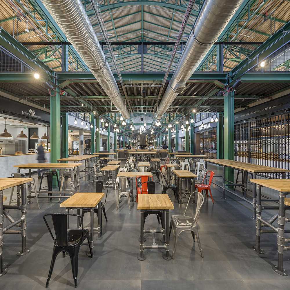 Interiors for an indoor market in Warsaw. Rough walls contrast with ...