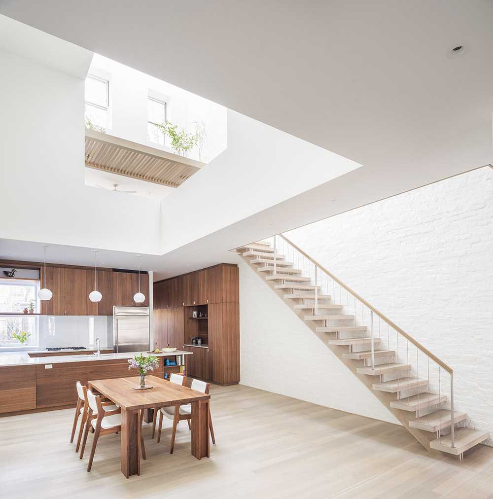 Interior renovation in Brooklyn. Triple-height space at the center of ...