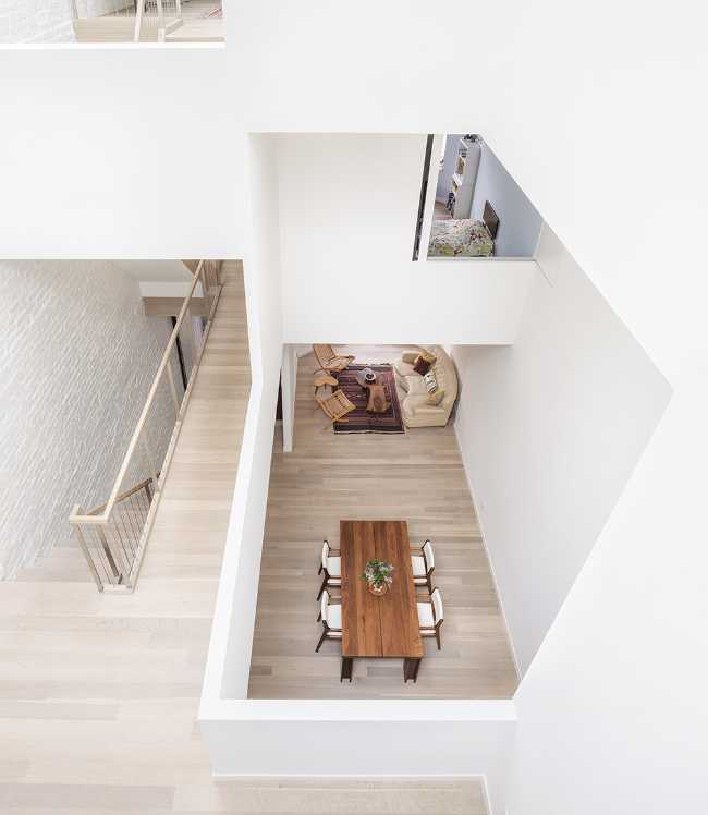 Interior renovation in Brooklyn. Triple-height space at the center of ...